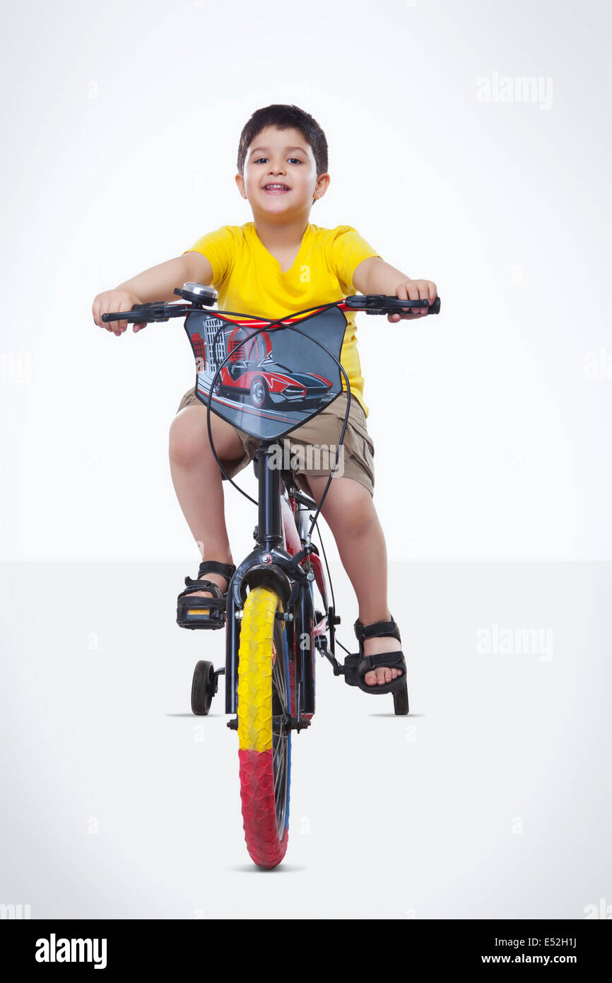 Full length portrait of boy riding bicycle over white background Stock ...