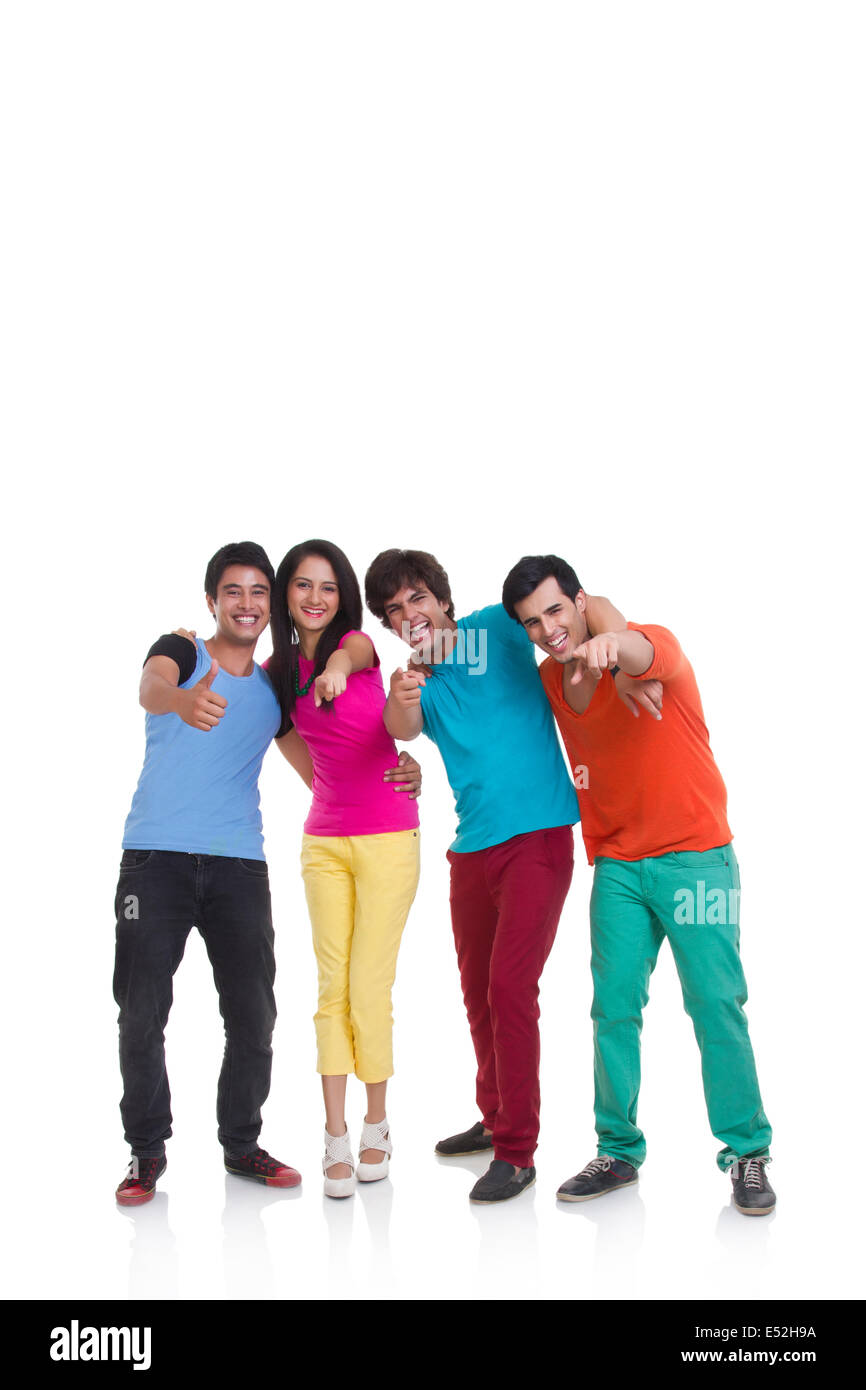 Full length of cheerful young friends pointing at you over white ...