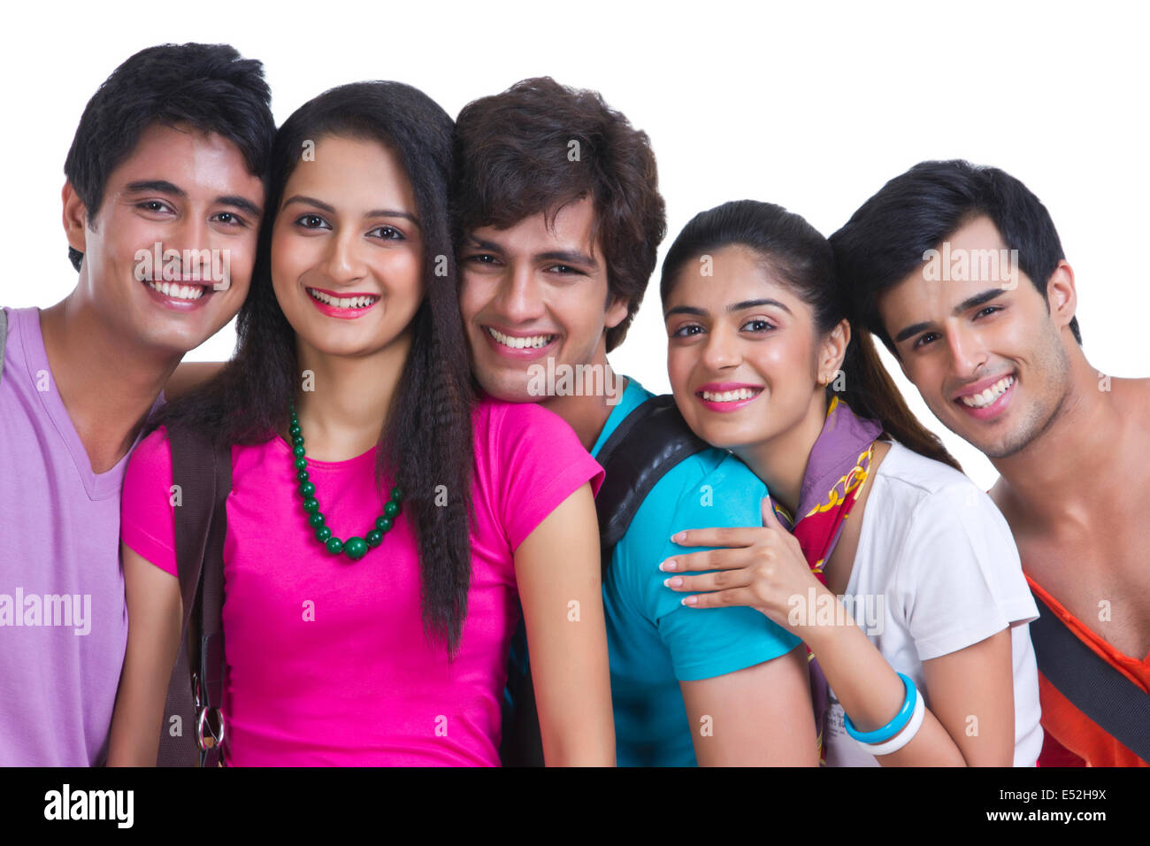 Portrait of university friends smiling together on white background ...