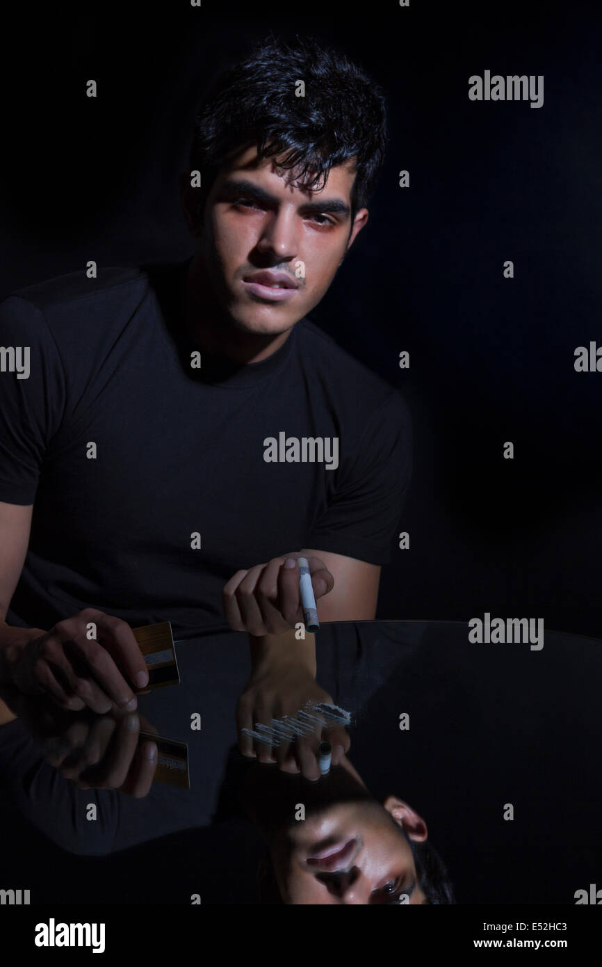 Portrait of drug addict with rolled up banknote and cocaine Stock Photo ...