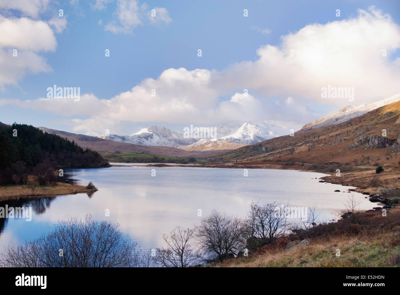Looking across Llynnau Mymbyr lakes to a snow covered Mount Snowdon on ...