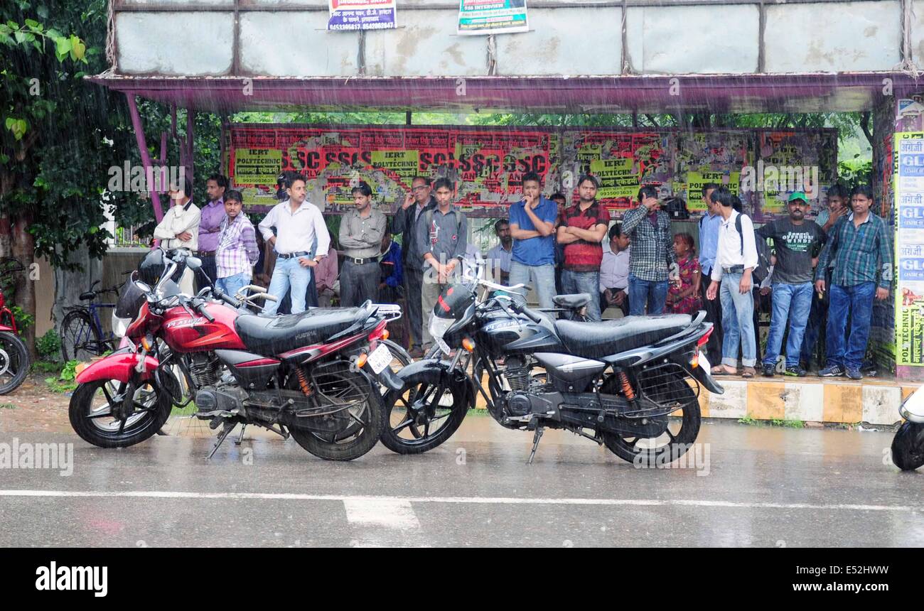 Allahabad, India. 18th July, 2014. People stay in shelter during rain ...