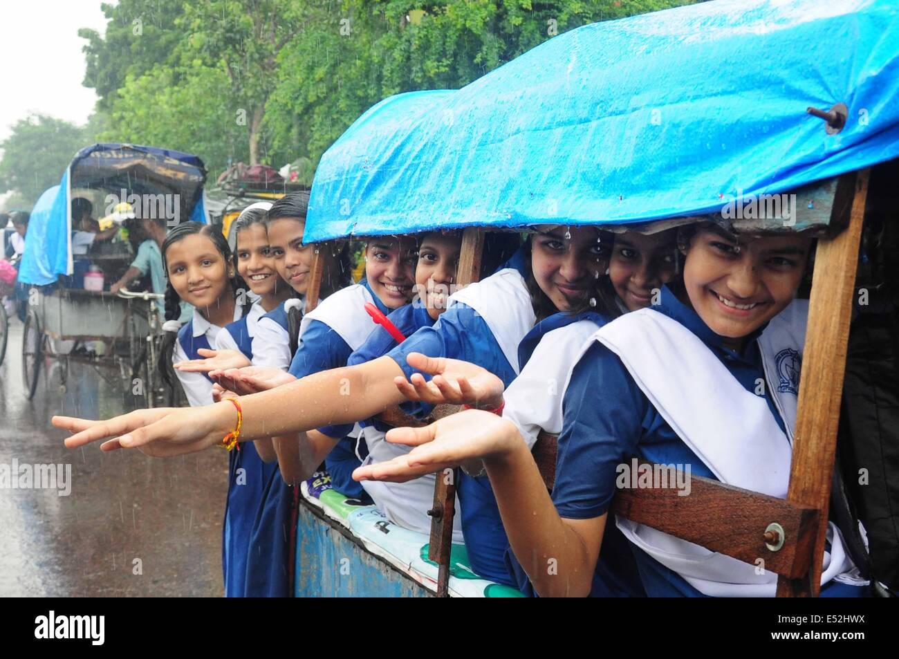Allahabad, India. 18th July, 2014. School children enjoying rain in ...