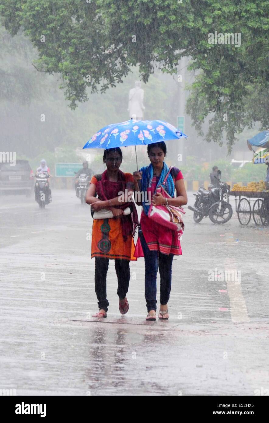 Allahabad, India. 18th July, 2014. Girls sharing umbrella during rain ...
