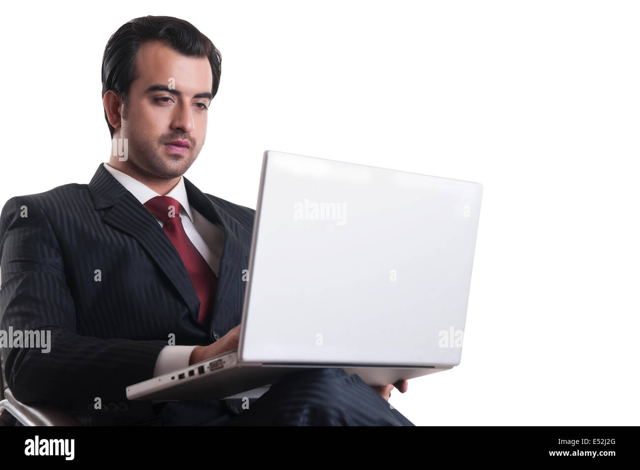 Young businessman using laptop over white background Stock Photo - Alamy