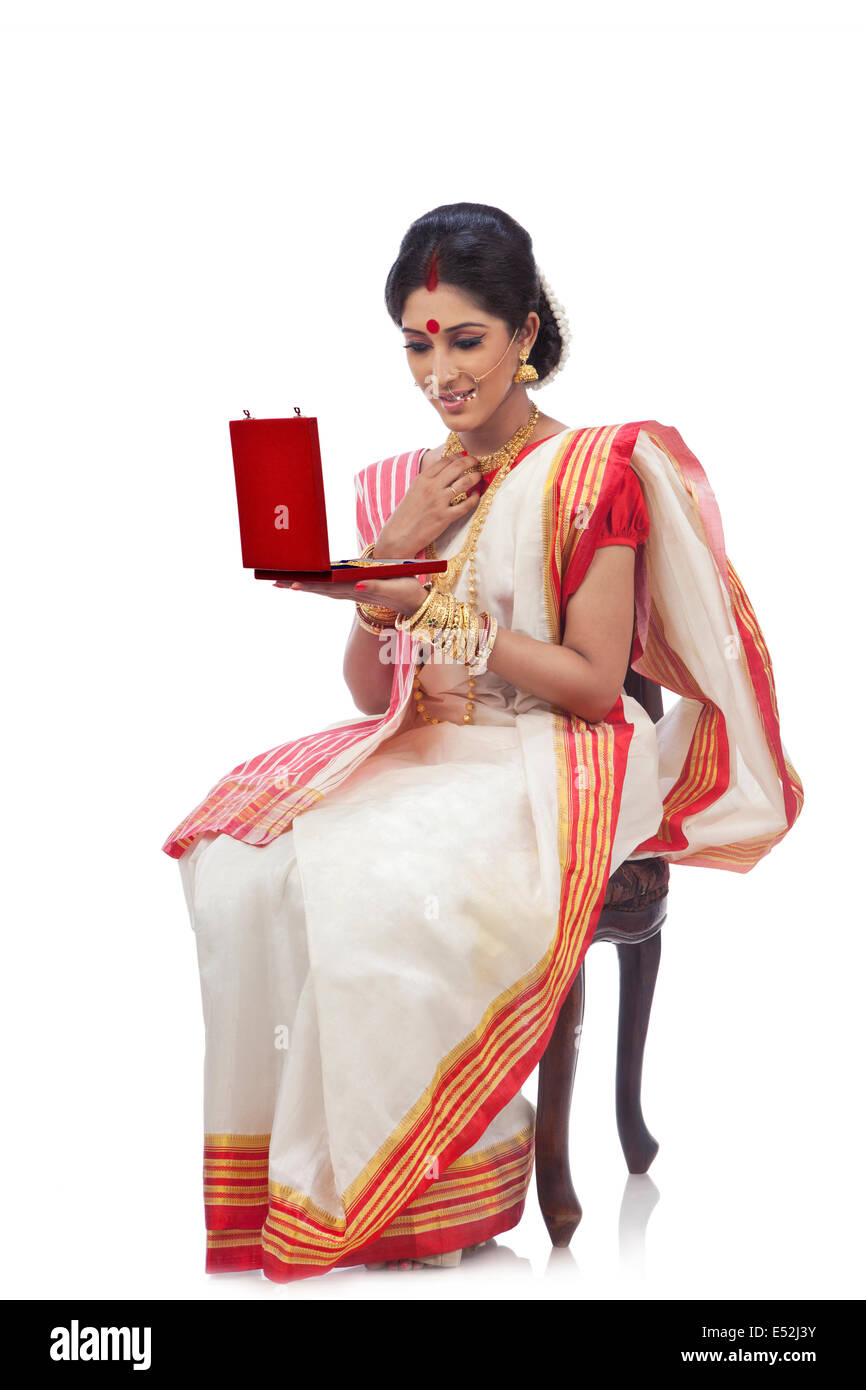 Woman smiling indoors holding red Cut Out Stock Images & Pictures - Alamy