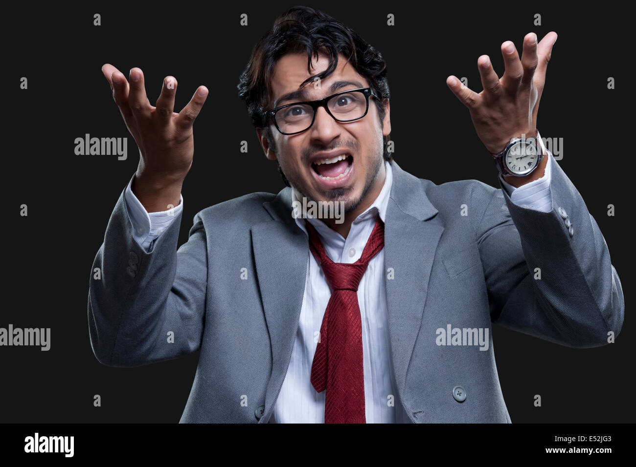 Angry businessman screaming against black background Stock Photo - Alamy