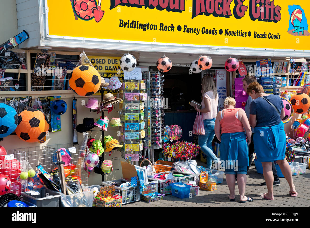 People tourists visitors shopping at beach seafront gift shop store in ...