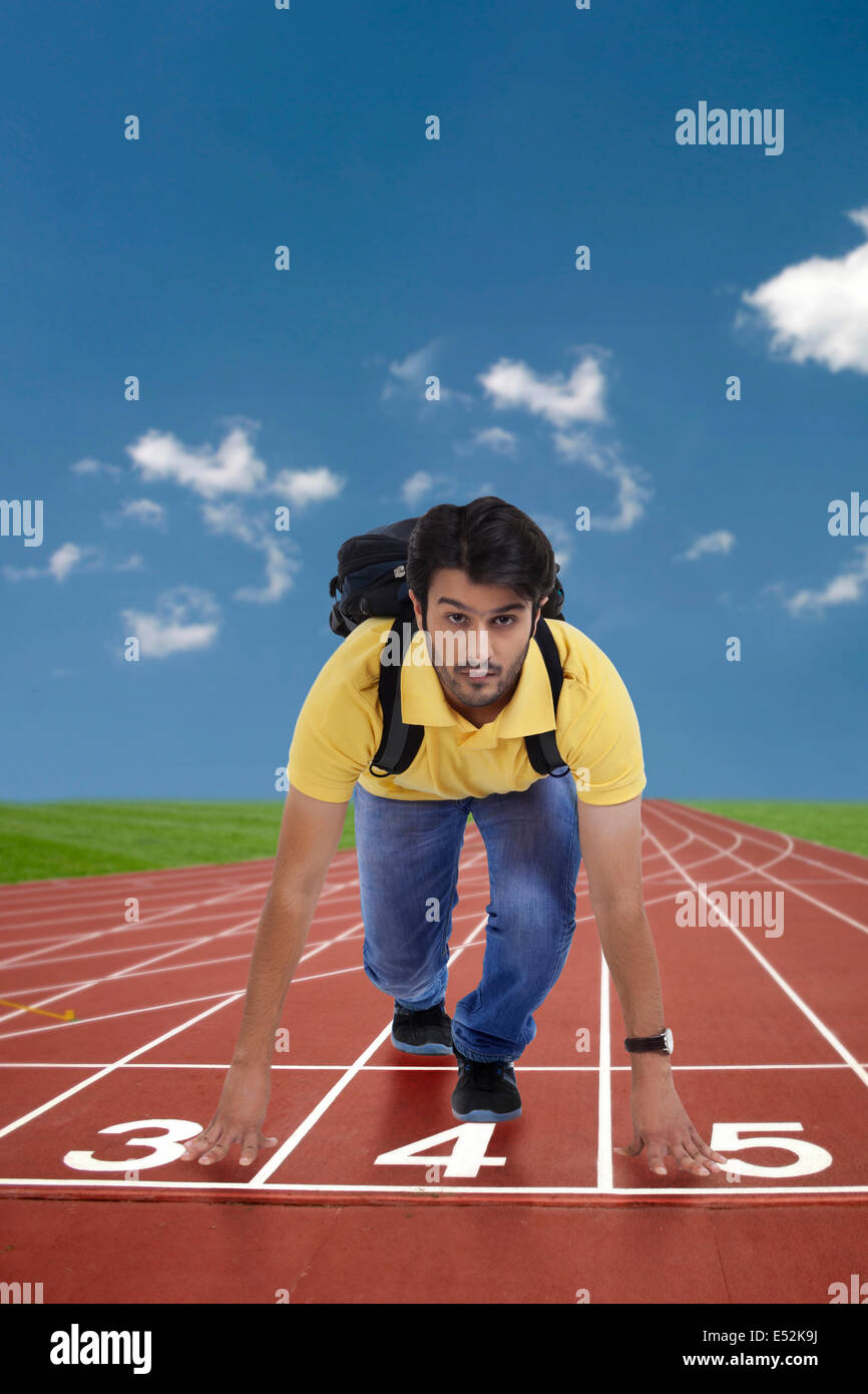 Young man at starting position of race Stock Photo - Alamy