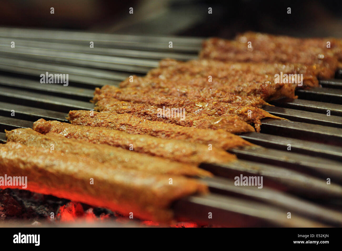 Minced meat being barbecued in a row Stock Photo - Alamy