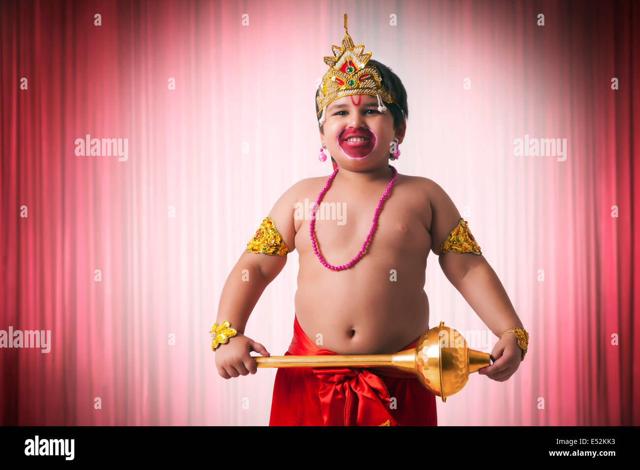Smiling boy dressed as God Hanuman against red theater curtain Stock ...