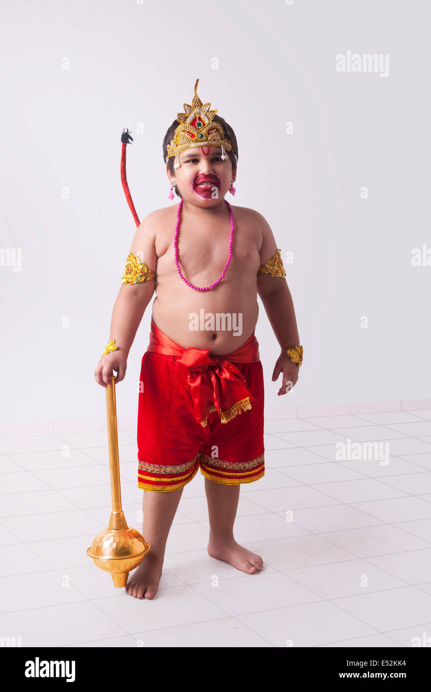 Full length of boy dressed as God Hanuman standing against wall Stock ...