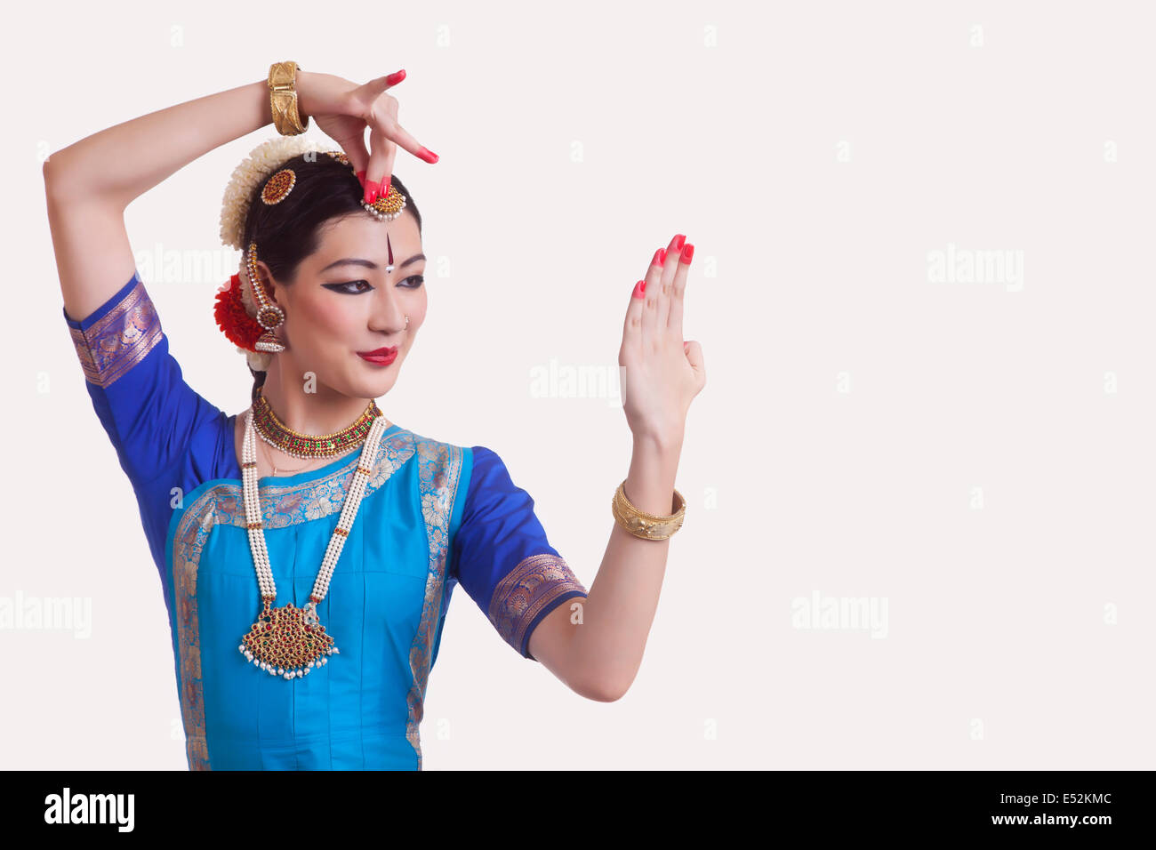 Woman performing Bharatanatyam the classical dance of India on white ...