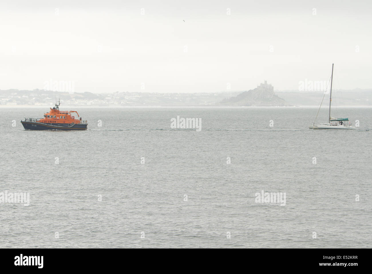 Newlyn, UK. 18th July, 2014. The Penlee RNLI Lifeboat tows a 30 foot ...