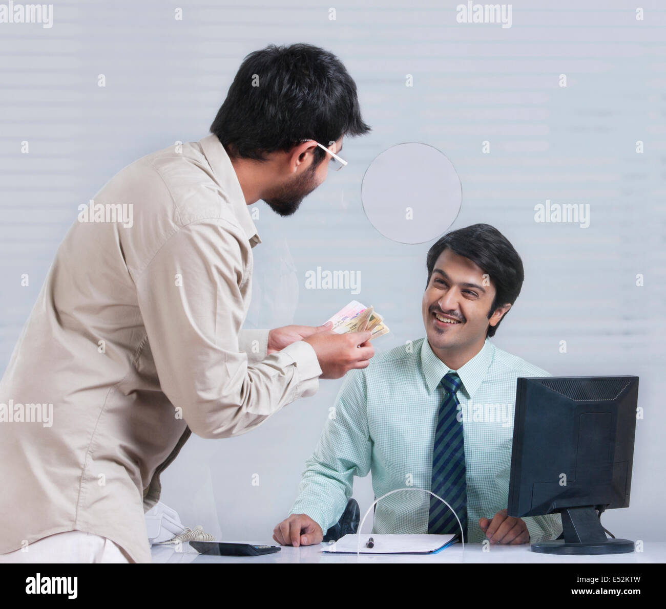 Young man making a money transaction Stock Photo - Alamy