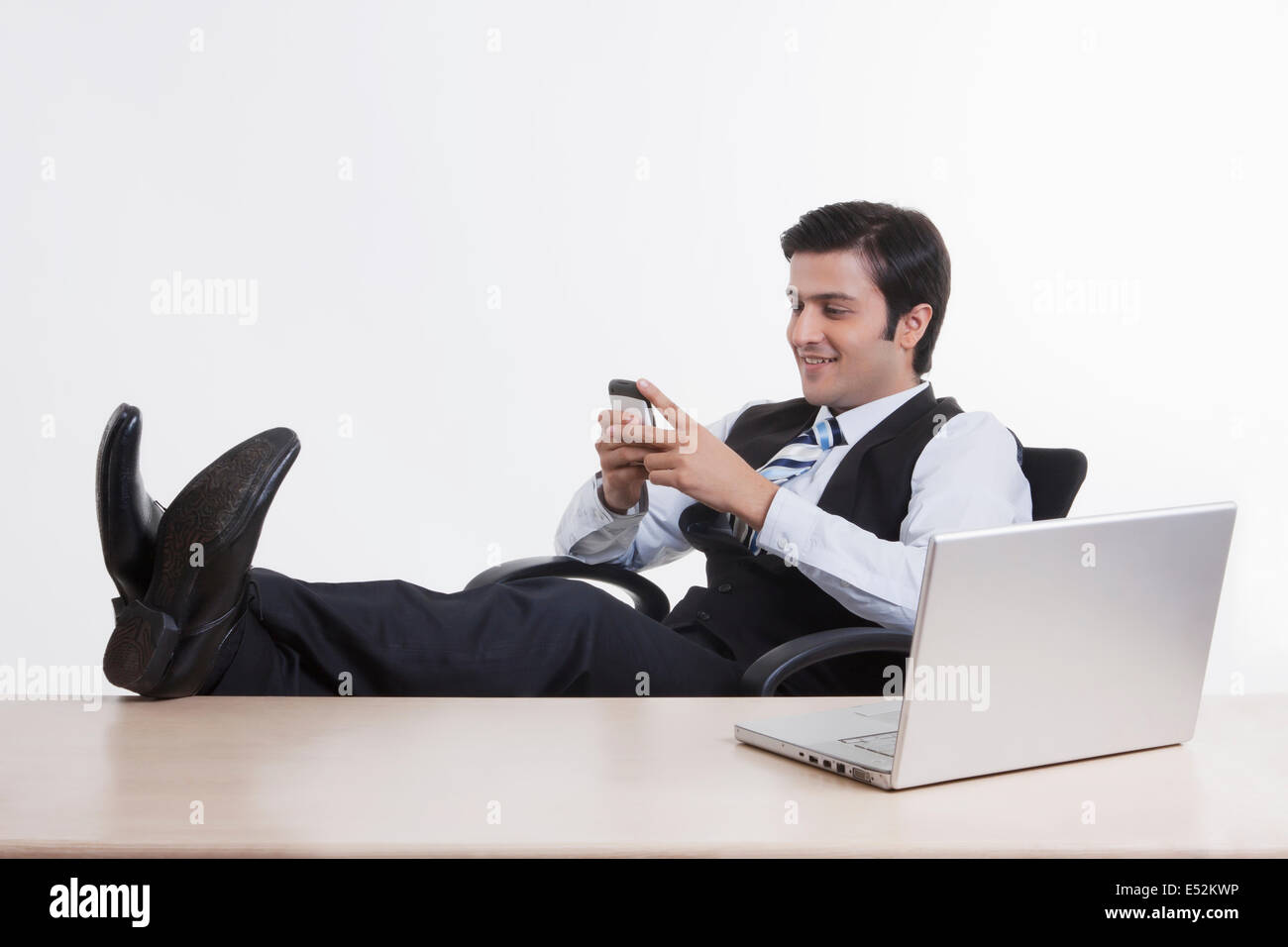 Businessman with his feet on the table Stock Photo - Alamy