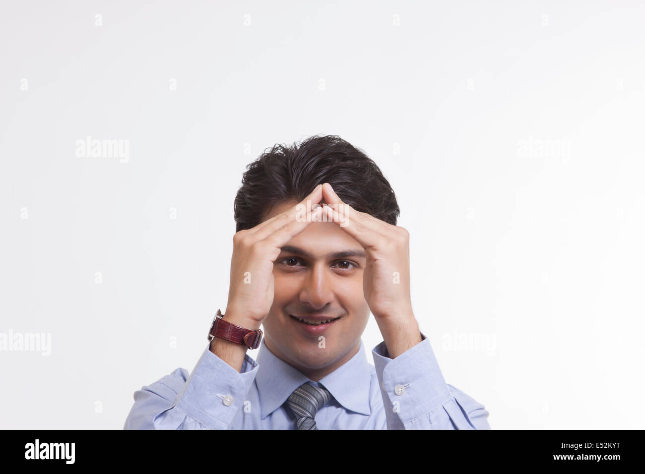 Businessman making house sign Stock Photo - Alamy
