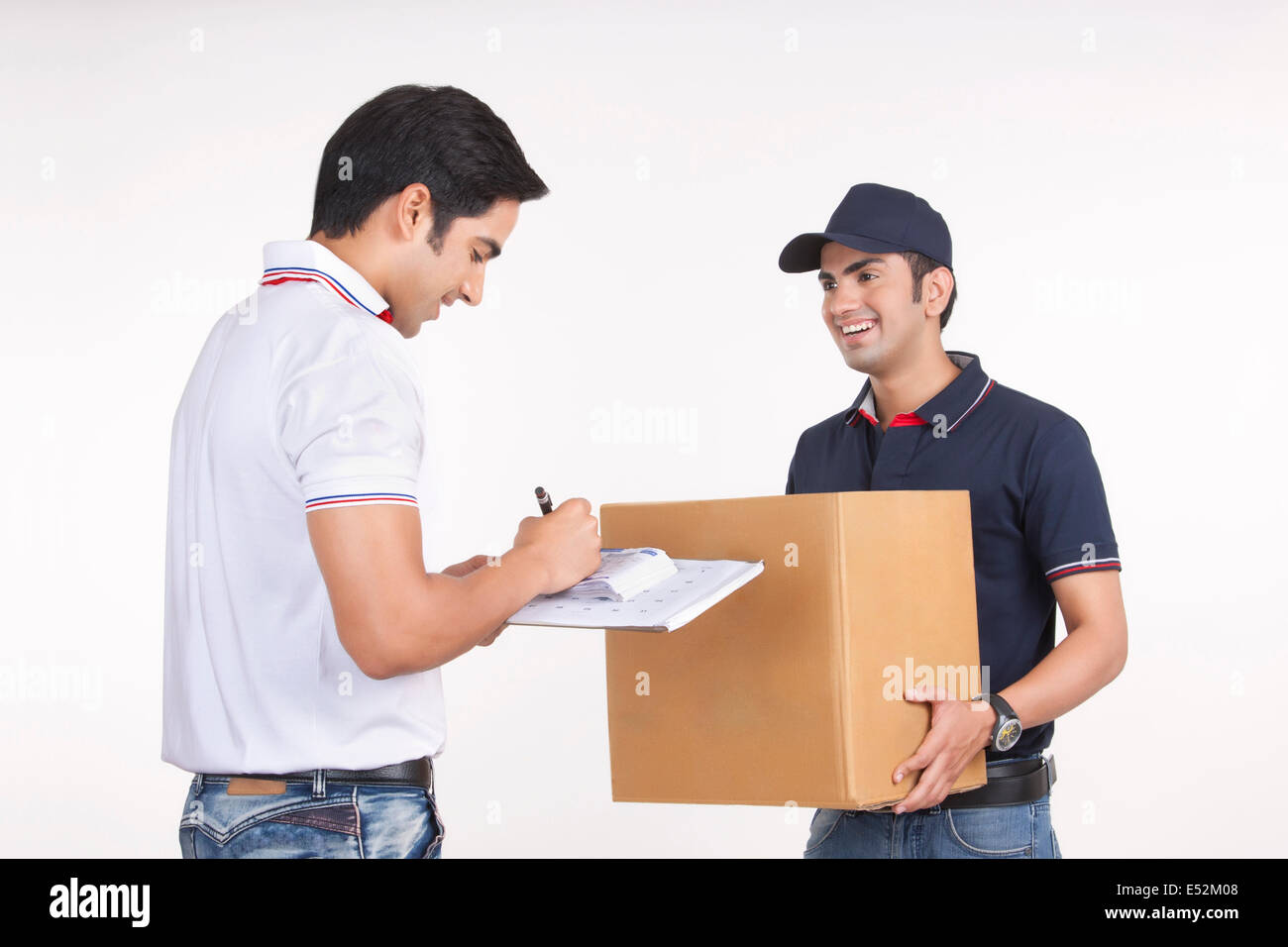 Delivery man delivering package to customer against white background ...