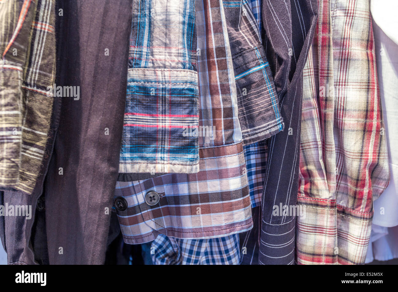 Collection of different men shirts sleeves in a wardrobe Stock Photo ...