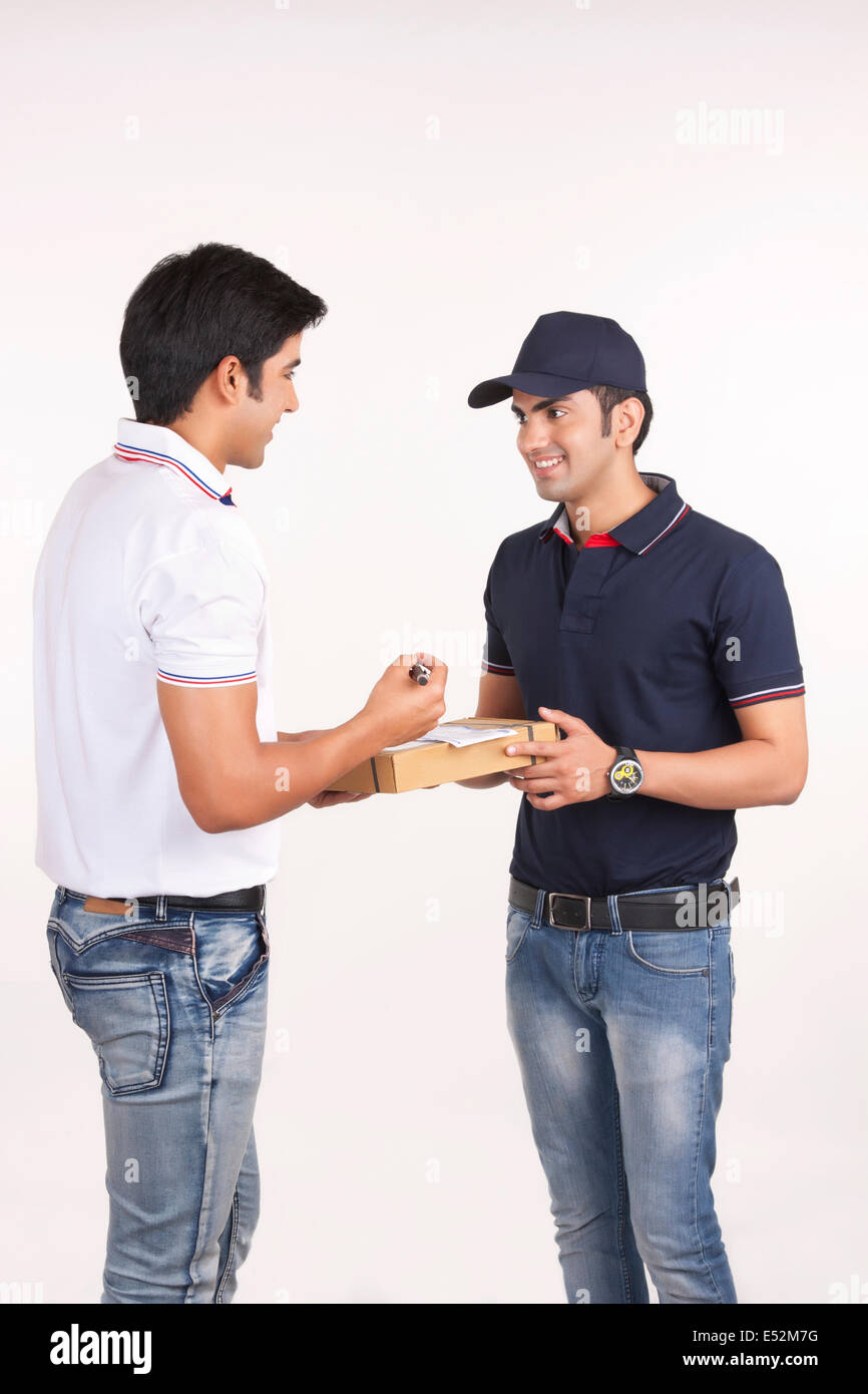 Customer receiving package from delivery man against white background ...