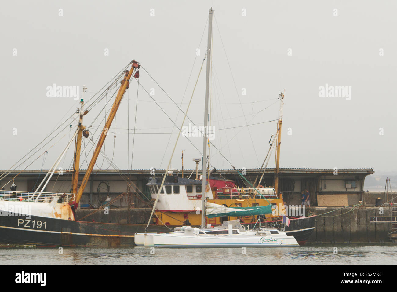 Newlyn, UK. 18th July, 2014. The Penlee RNLI Lifeboat tows a 30 foot ...