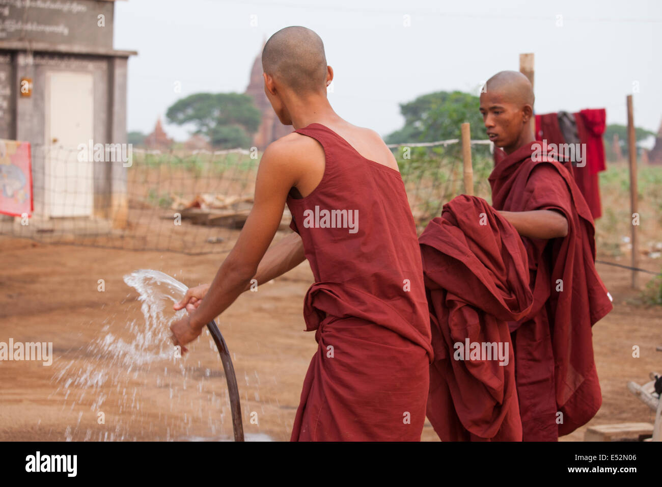Young monks help clean the grounds of their small Bagan monastery ...