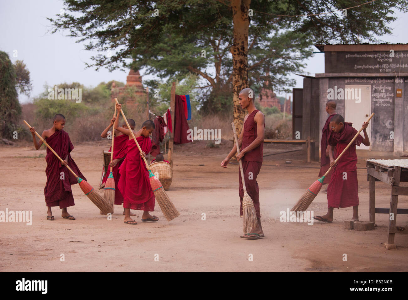 Young monks help clean the grounds of their small Bagan monastery ...
