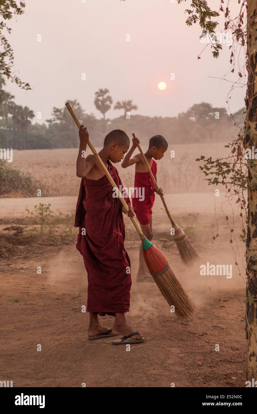 Young monks help clean the grounds of their small Bagan monastery ...