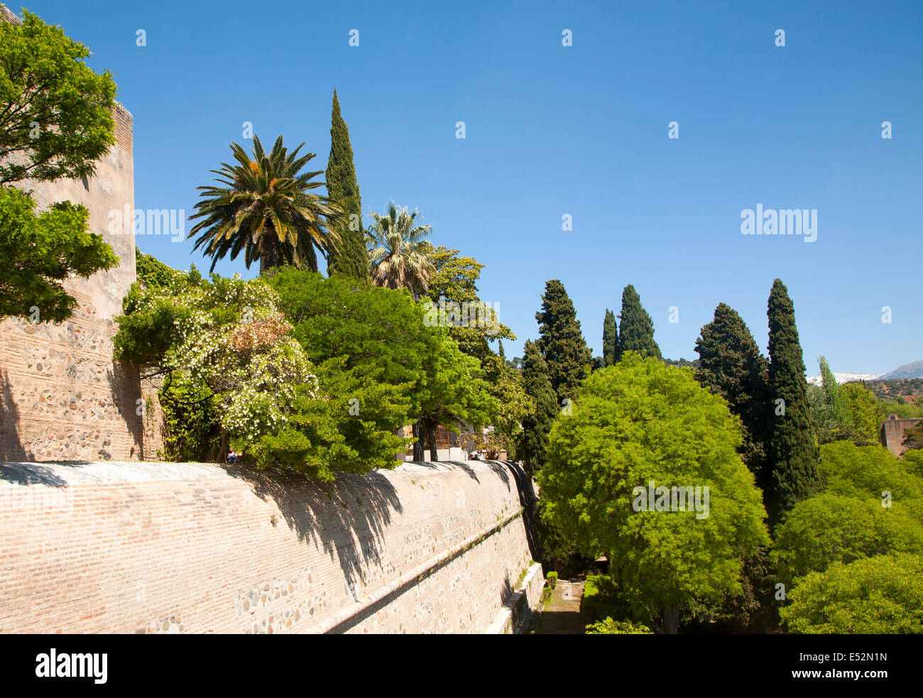 Greenery trees blue sky and historic walls of the Alhambra, Granada ...