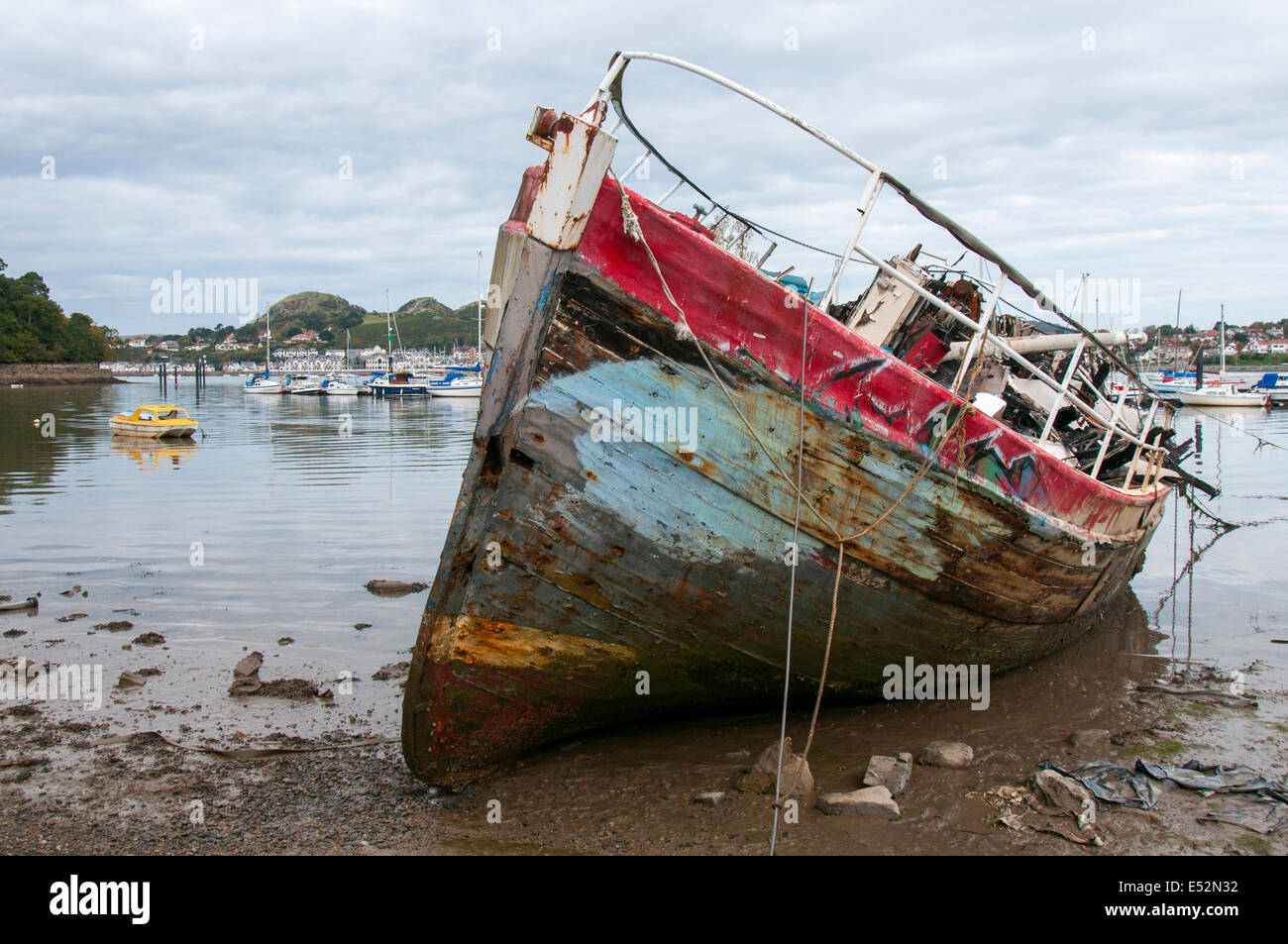 An old boat on the beach in the harbour at Conwy, North Wales UK Stock ...