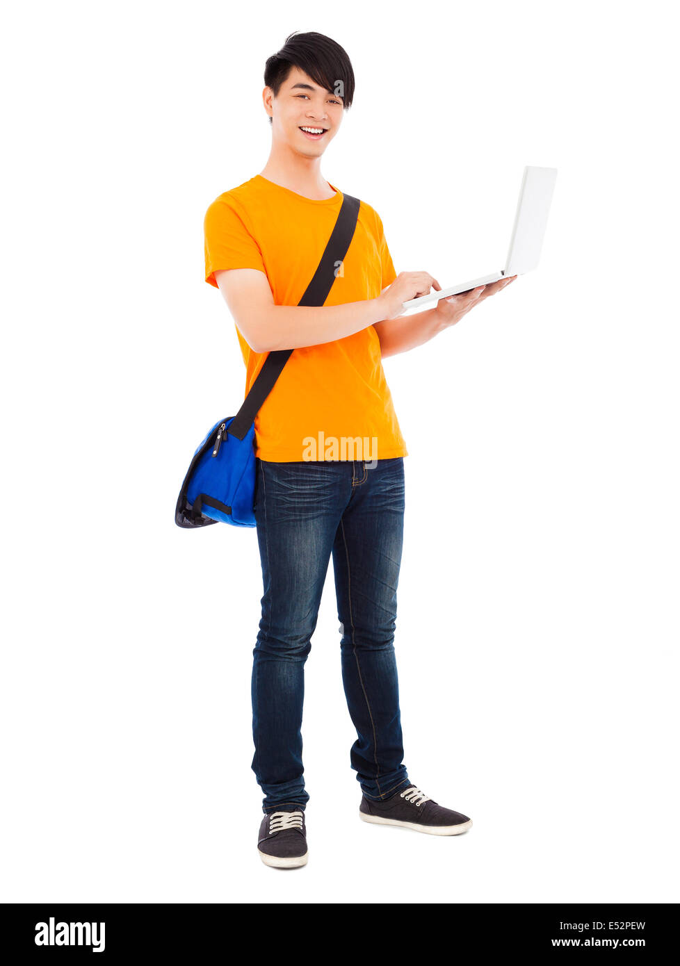 happy young student standing and using laptop Stock Photo - Alamy