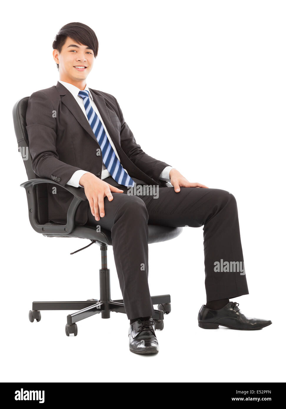 handsome Young business man sitting on a chair Stock Photo - Alamy