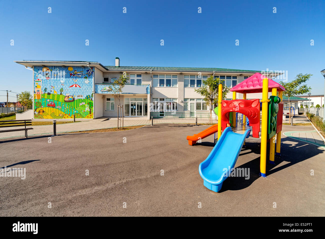 preschool building exterior with playground on a sunny day Stock Photo ...