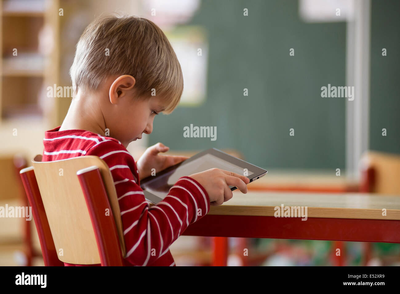 school boy in the classroom with iPad Stock Photo - Alamy