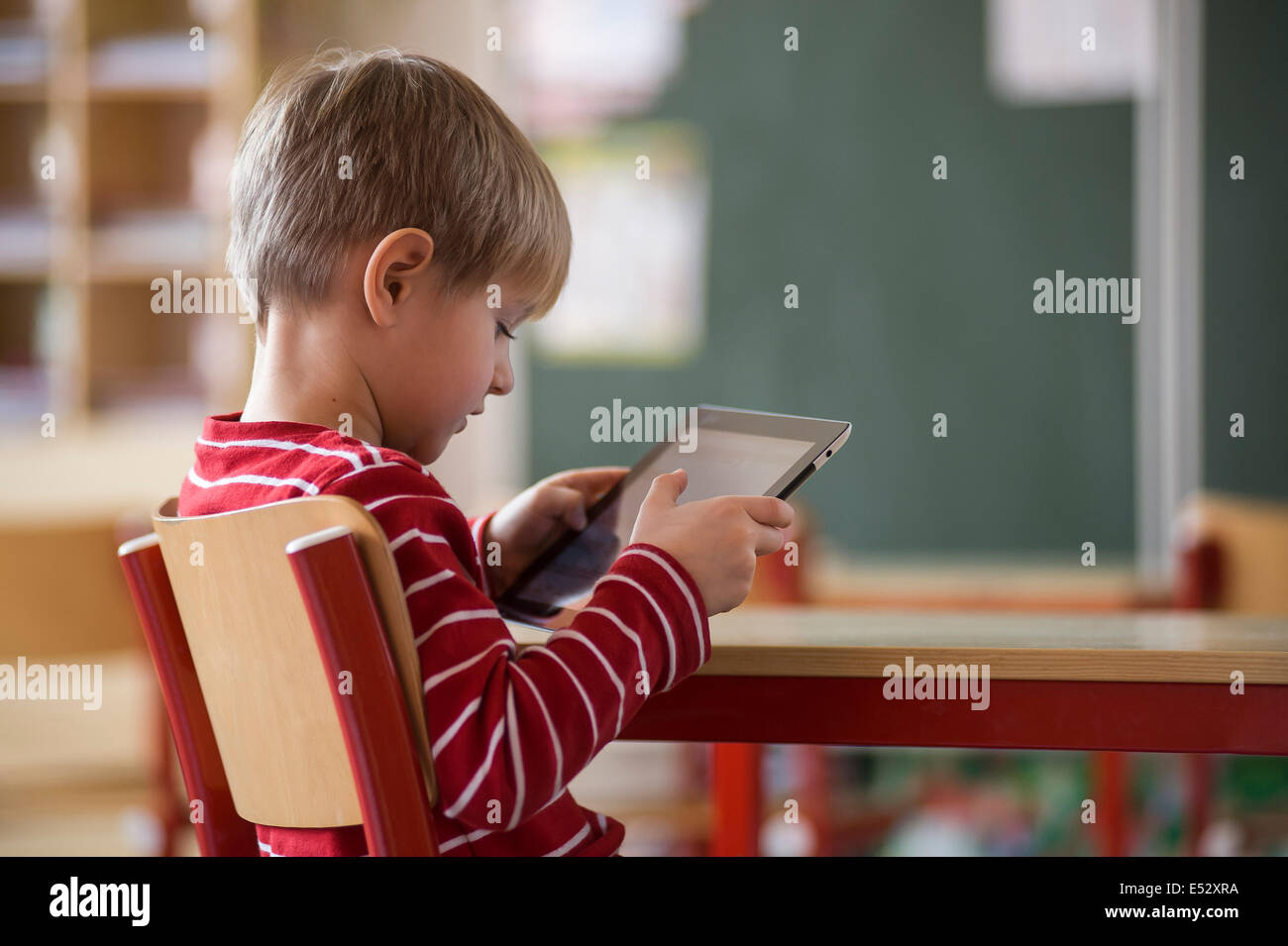 school boy in the classroom with iPad Stock Photo - Alamy