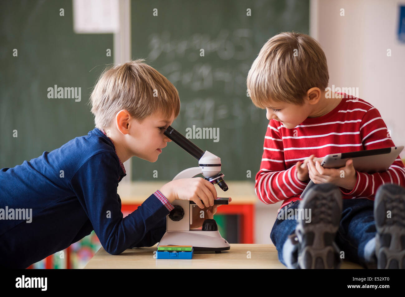 two school boys working with microscope Stock Photo - Alamy