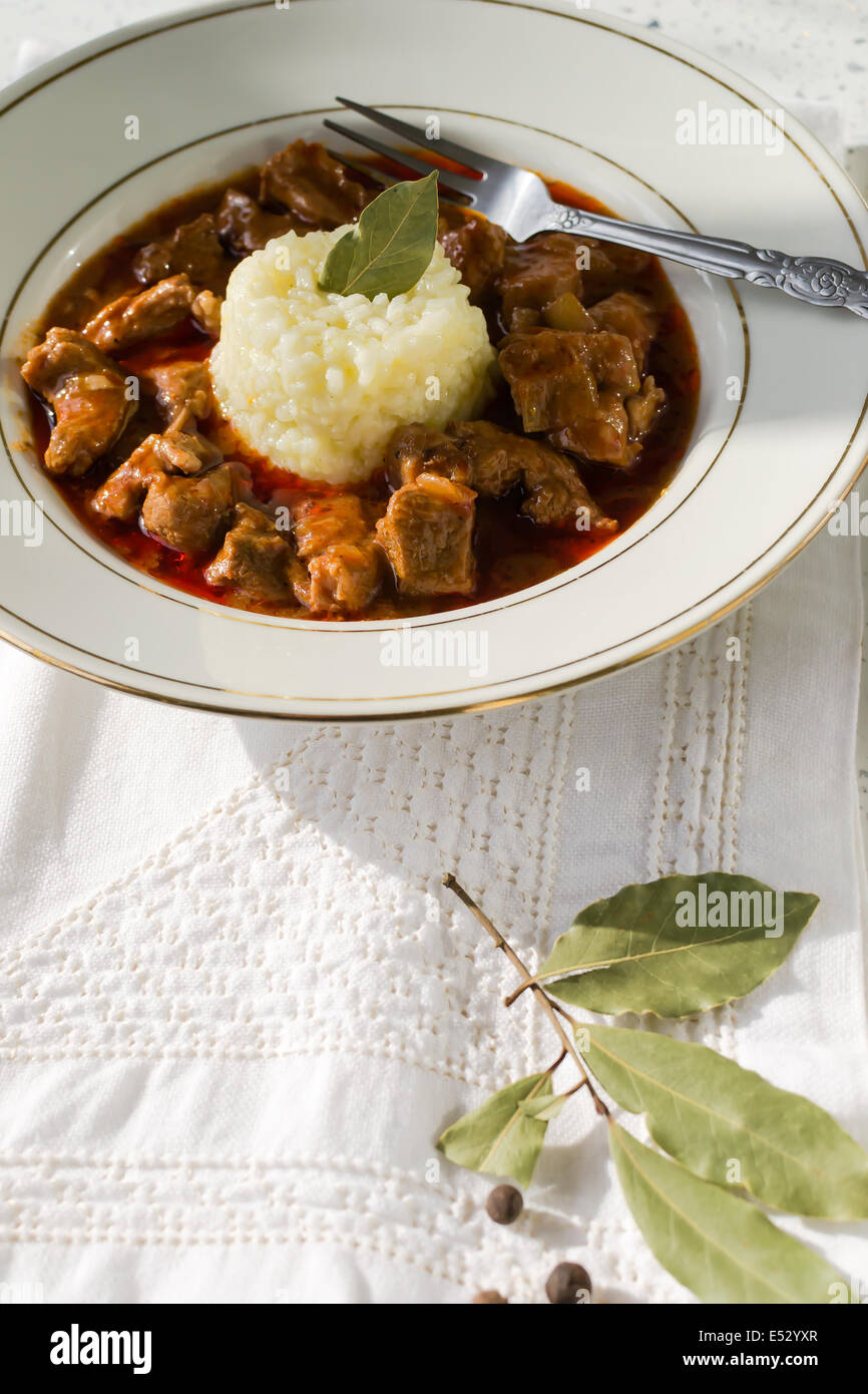 A Bulgarian-style pork stew with tomato sauce with red wine and white ...