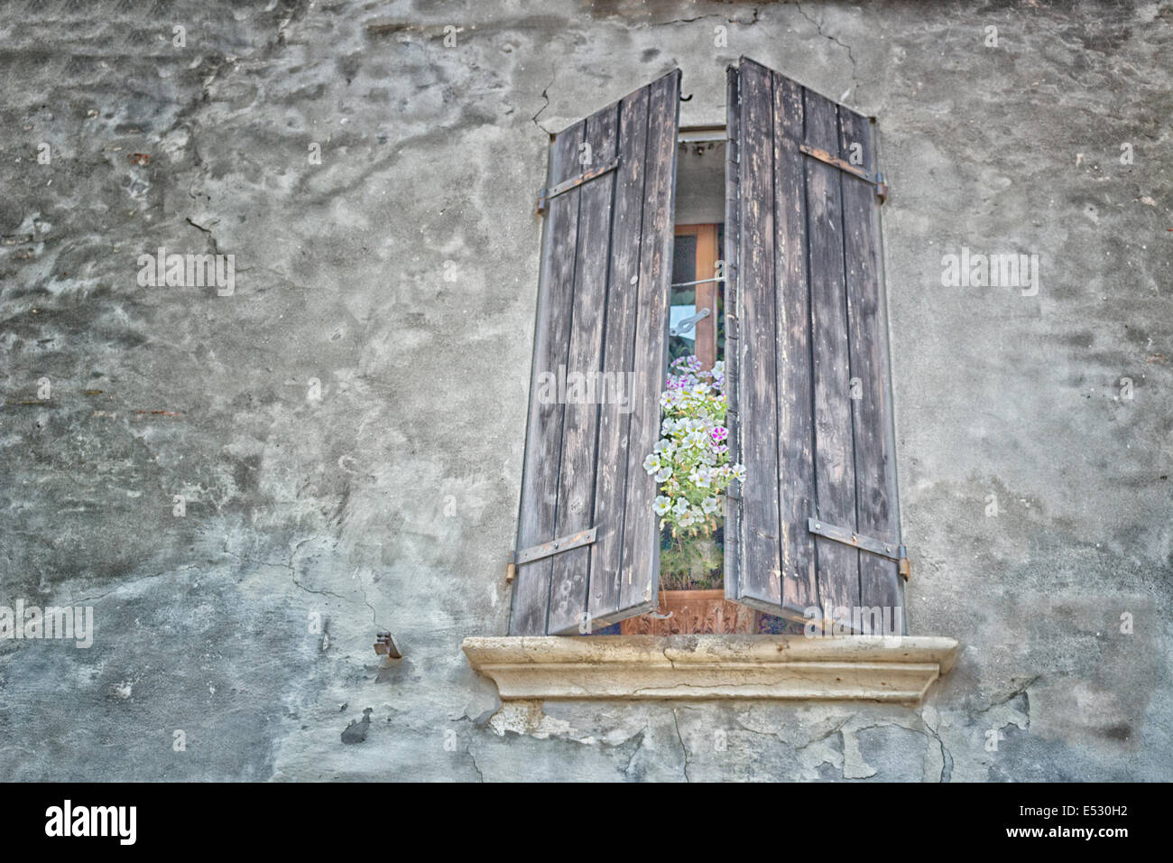 Old windows with wood closing and flowers Stock Photo - Alamy