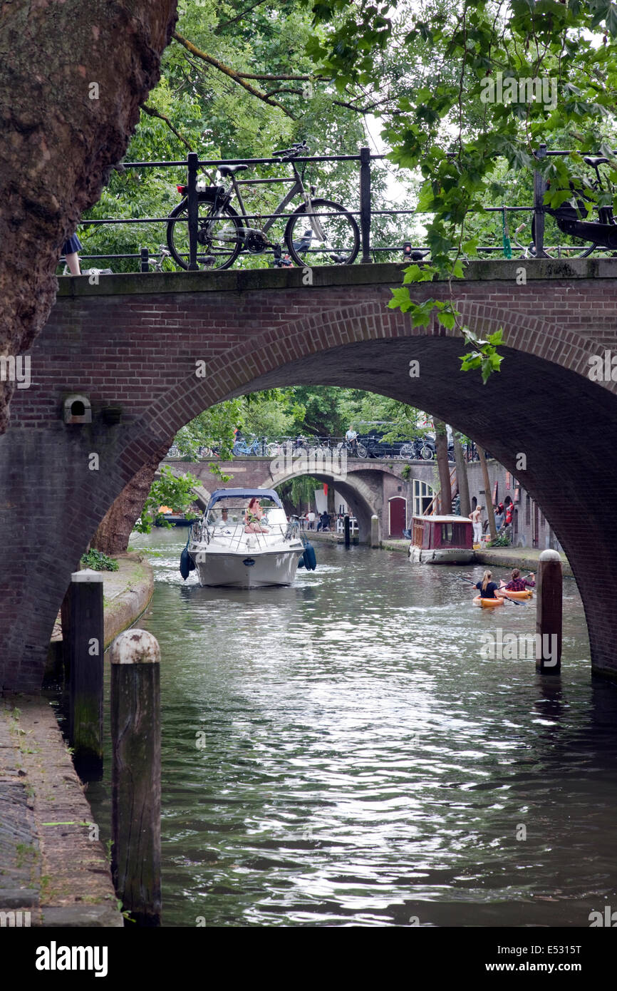 Pleasure boat approaching a bridge on the canal in Utrecht, Netherlands ...
