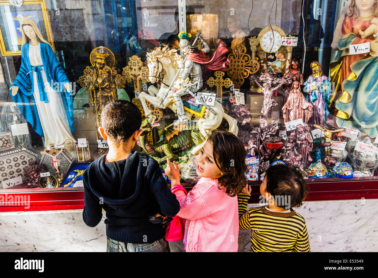 Coptic children staring at the window of a souvenirs shop at Deir al ...