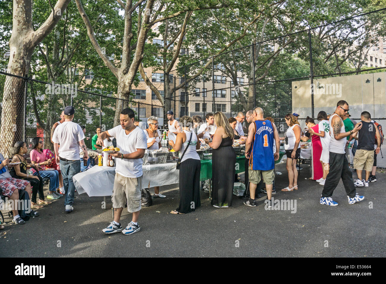 hungry people in serving line for delicious picnic supper as man leaves ...