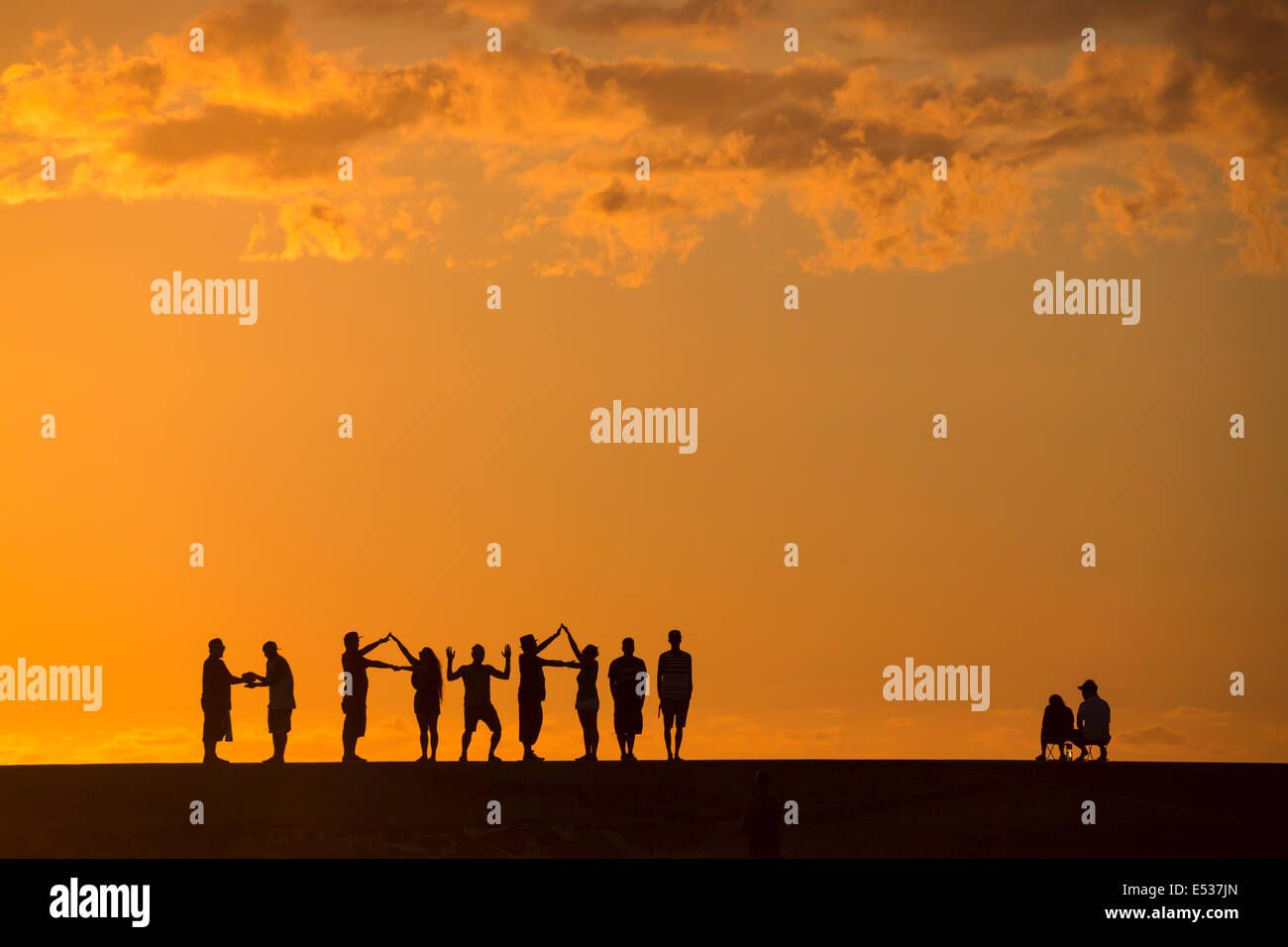 Silhouetted tourists spelling the word Hawaii with there bodies at Ala ...