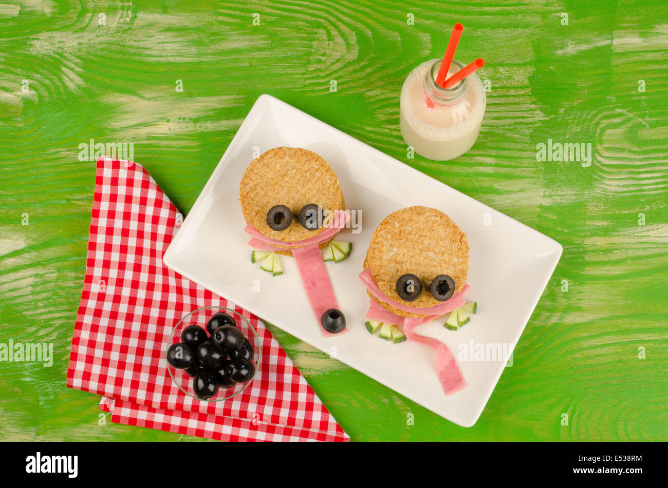 Funny kid snack with crunchy crackers resembling faces Stock Photo - Alamy