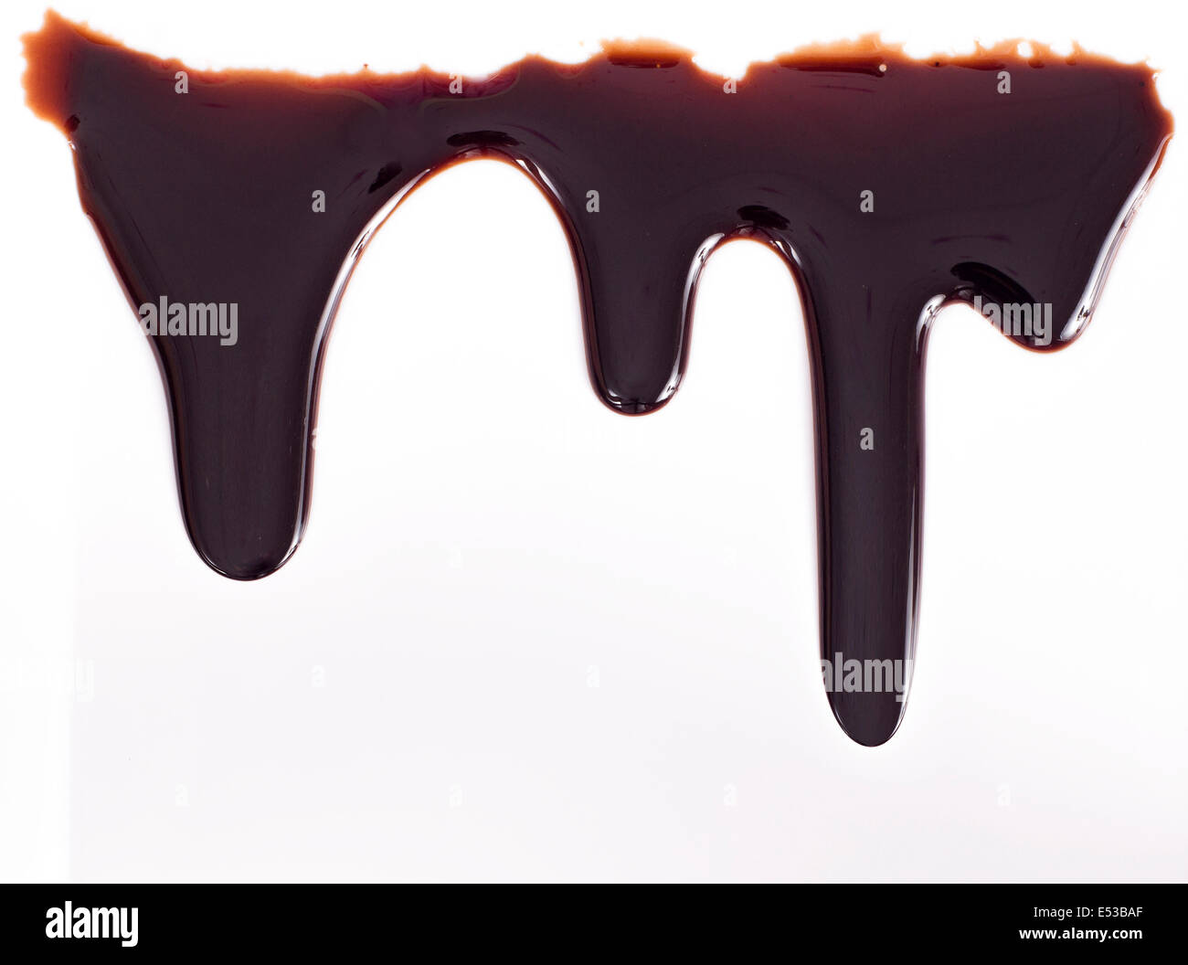 Melted chocolate dripping on white background Stock Photo - Alamy