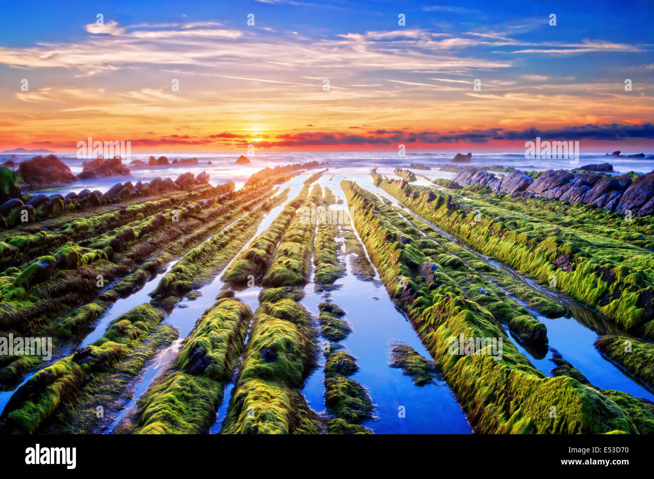 sunset at barrika coast with rocks and moss. Basque Country Stock Photo ...