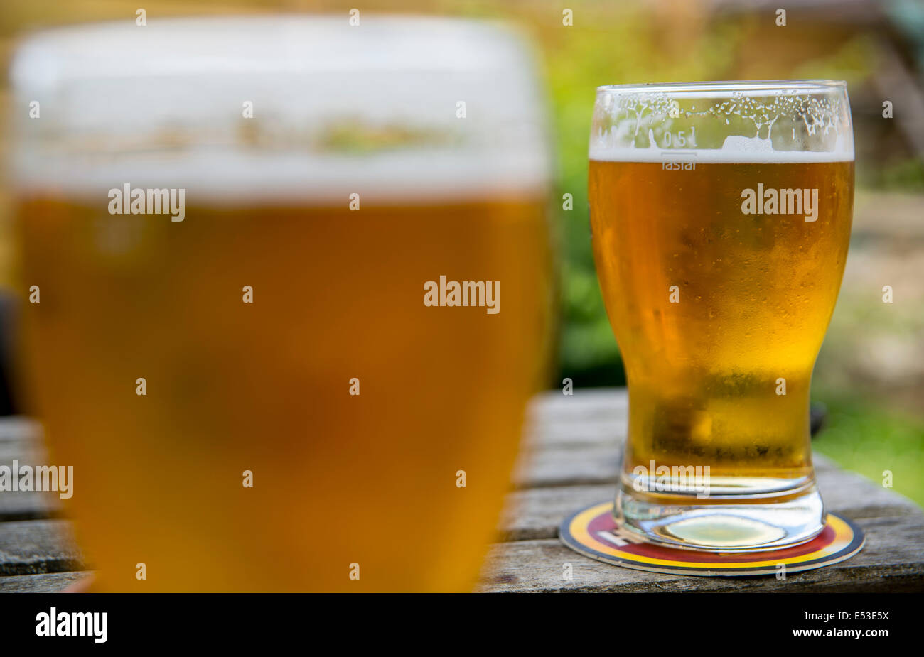 Pints of lager sat on a pub table Stock Photo - Alamy