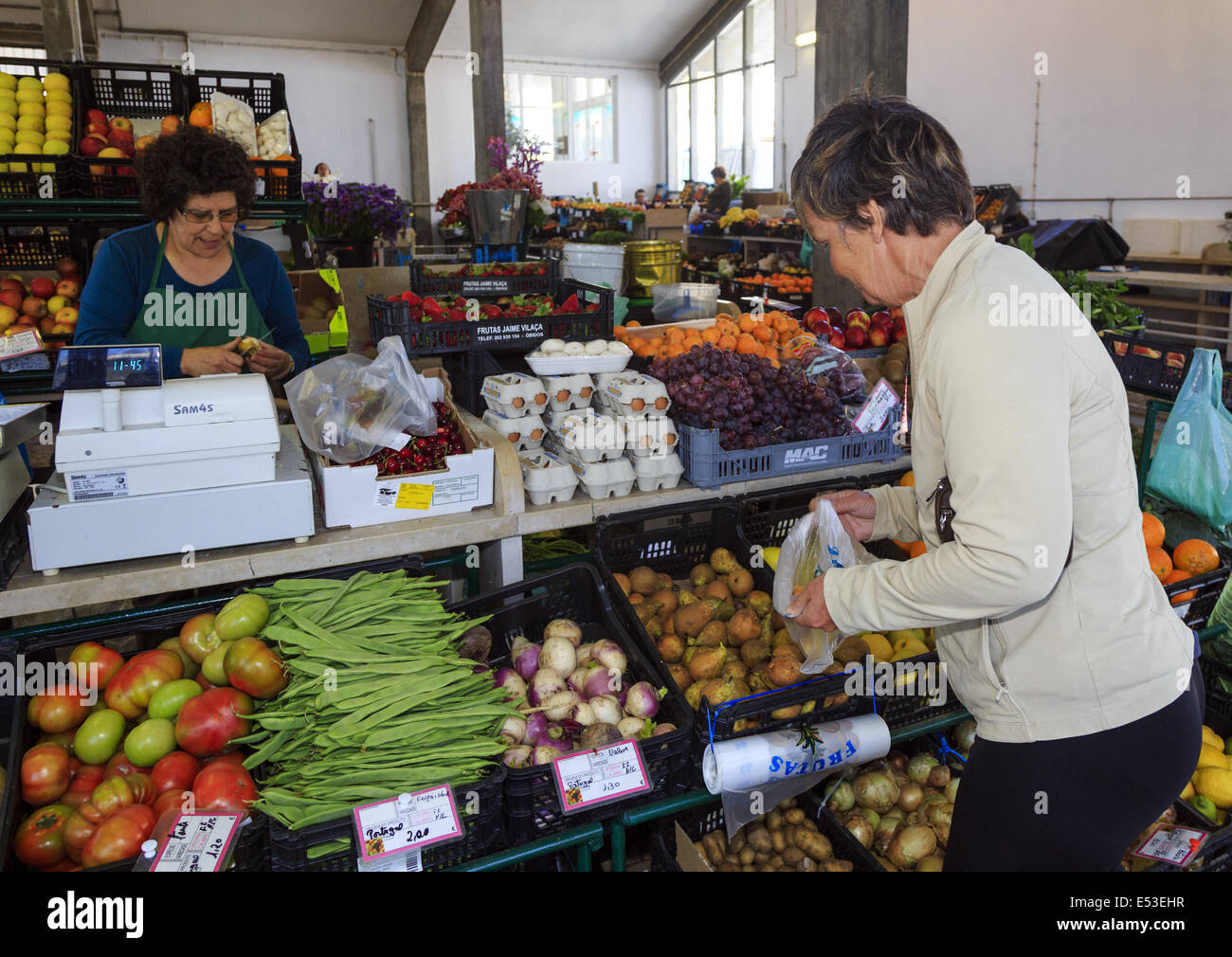 Woman buying fruit and vegetables at traditional local fruit and ...