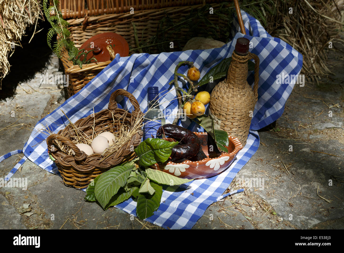 Wicker picnic basket and Wicker Wrapped Wine Jug in a rustic setting ...