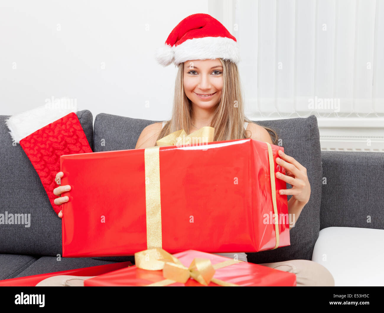 Cute woman excited about presents Stock Photo - Alamy