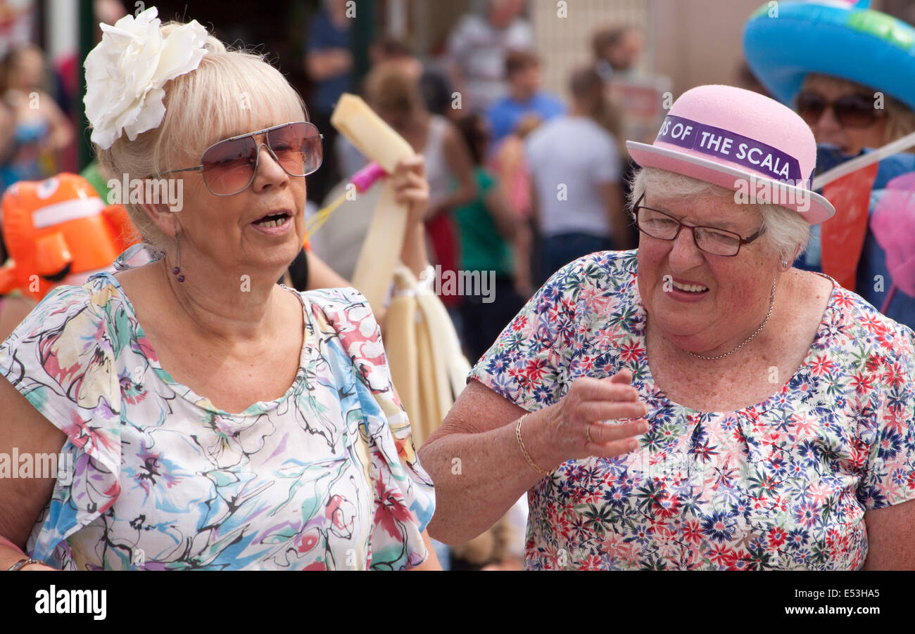 Two ladies having a laugh at Prestatyn carnival parade in Wales, UK ...